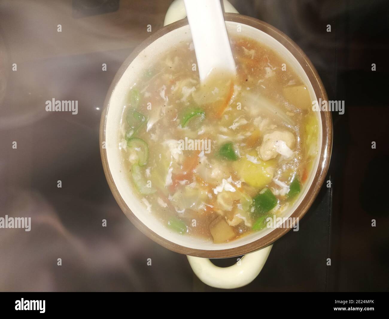 hot and fresh soup in the bowls at dining table in the room Stock Photo ...