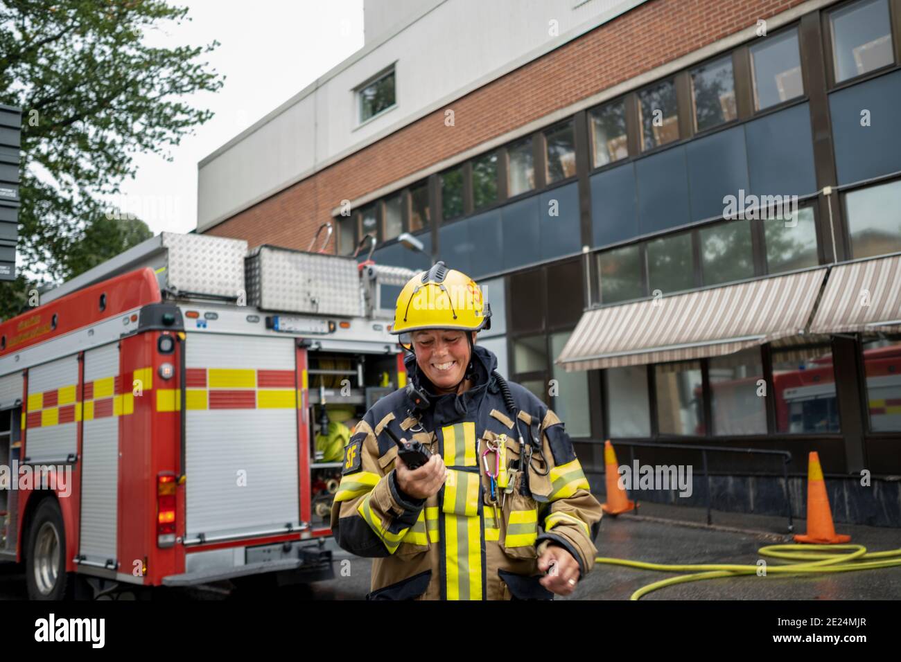 Firefighter talking via walkie talkie Stock Photo - Alamy