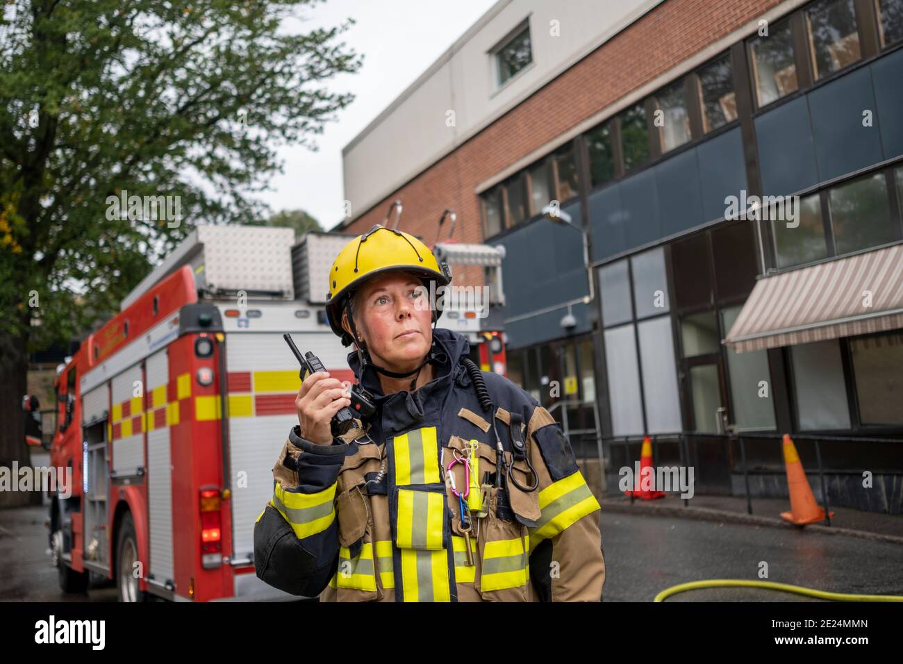 Firefighter talking via walkie talkie Stock Photo - Alamy