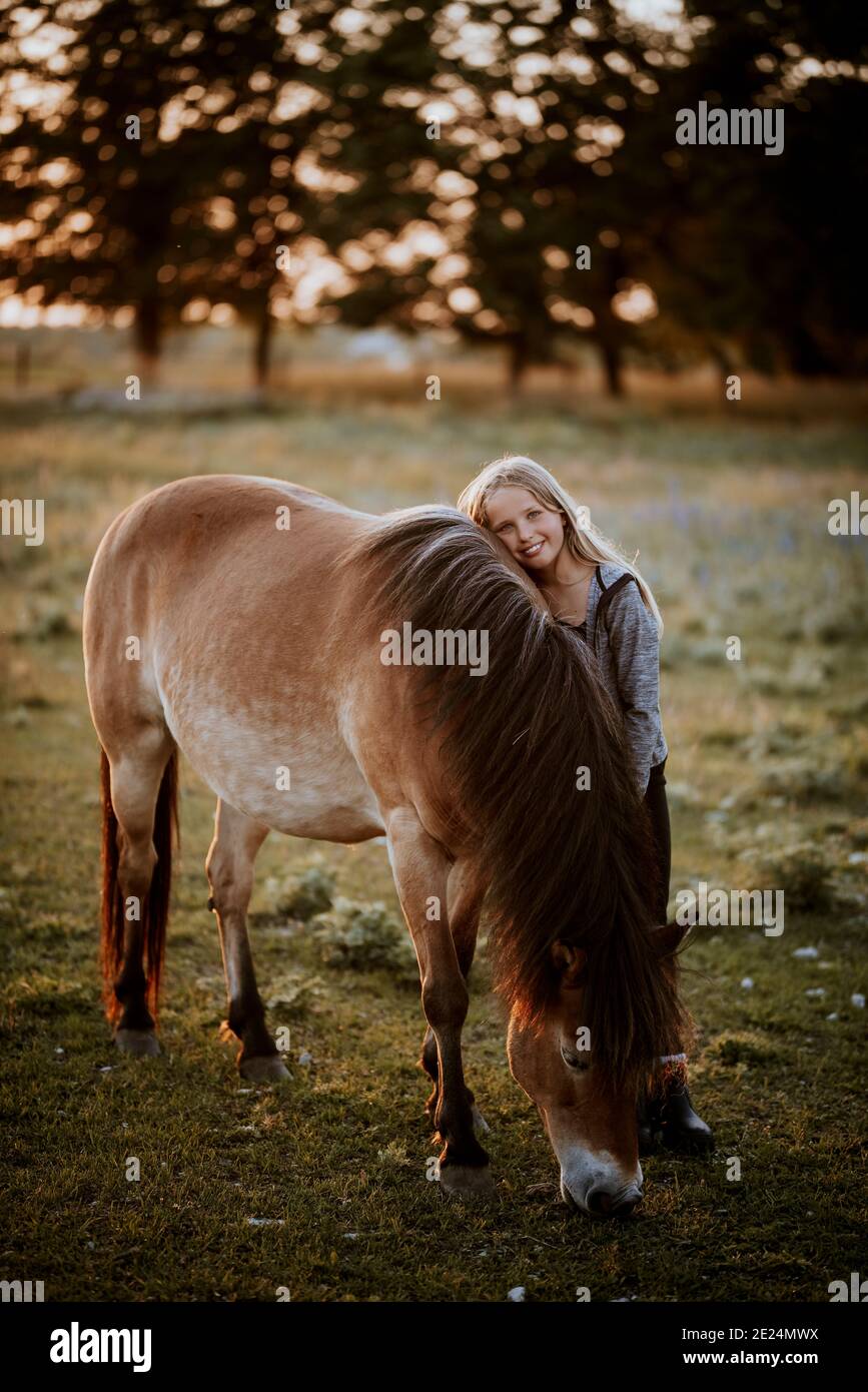 Girl hugging pony hi-res stock photography and images - Alamy