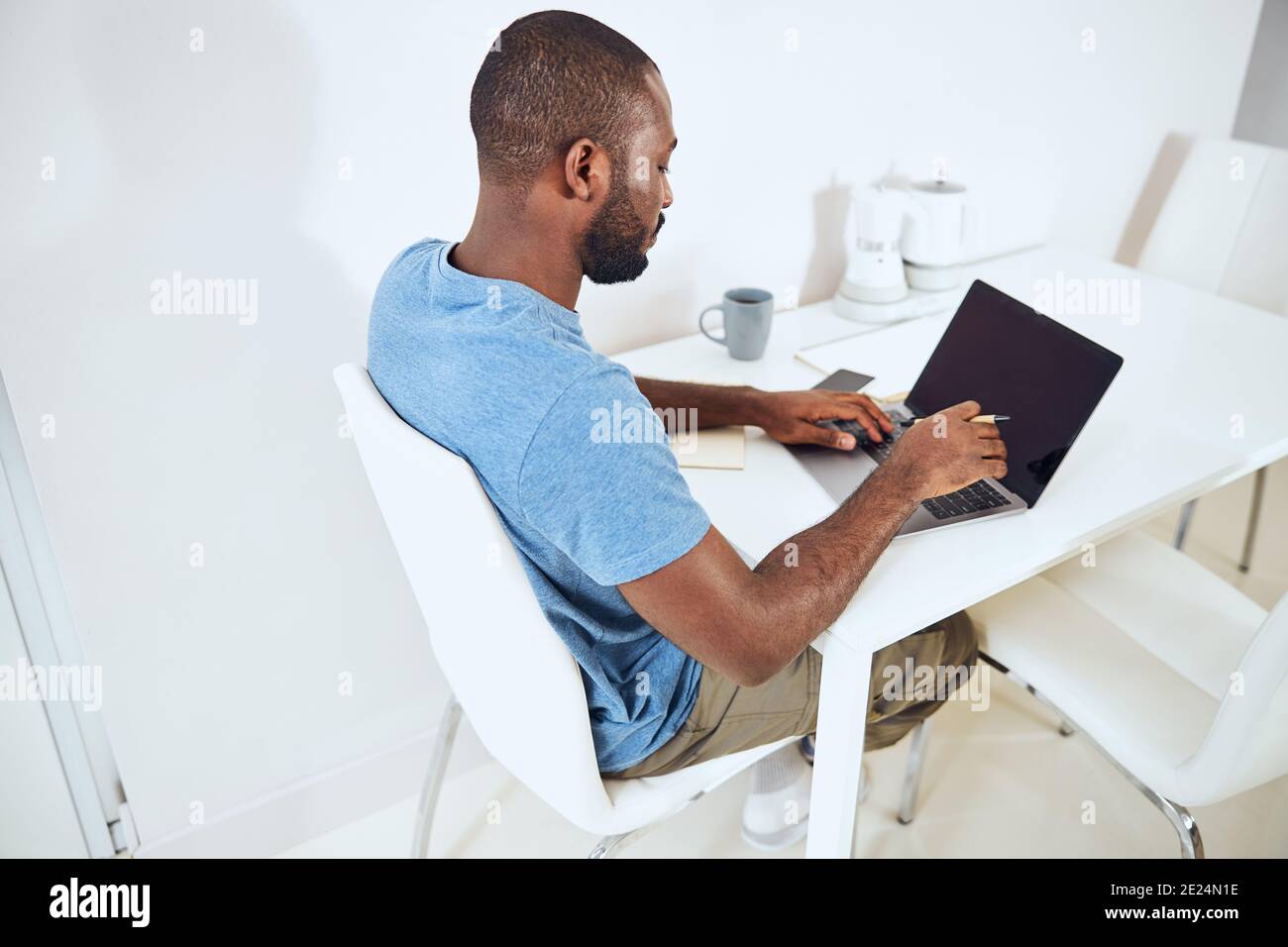Multiracial man typing on laptop hi-res stock photography and images ...