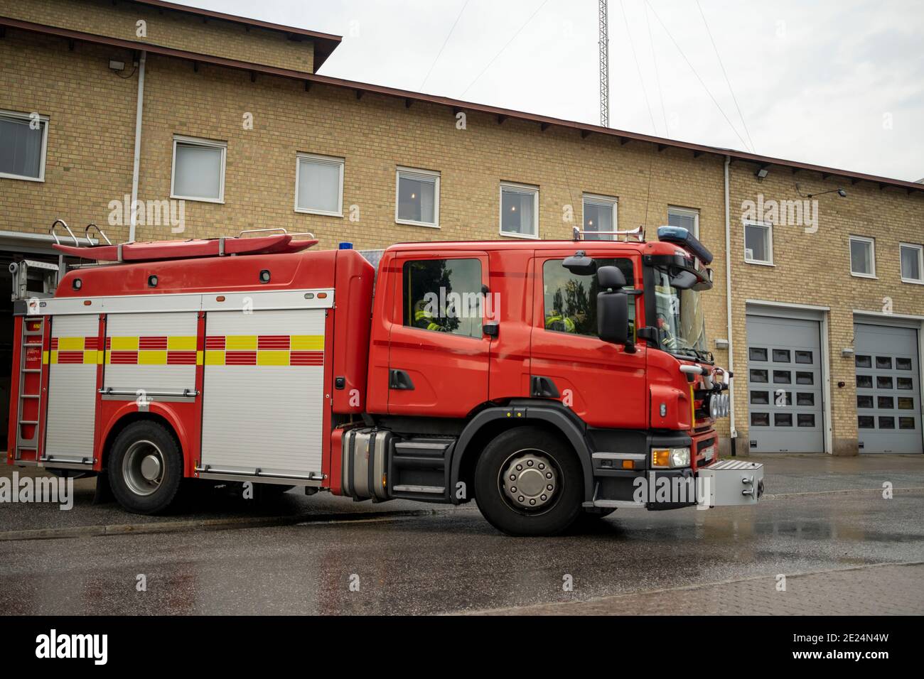 Fire engine in front of fire station Stock Photo - Alamy