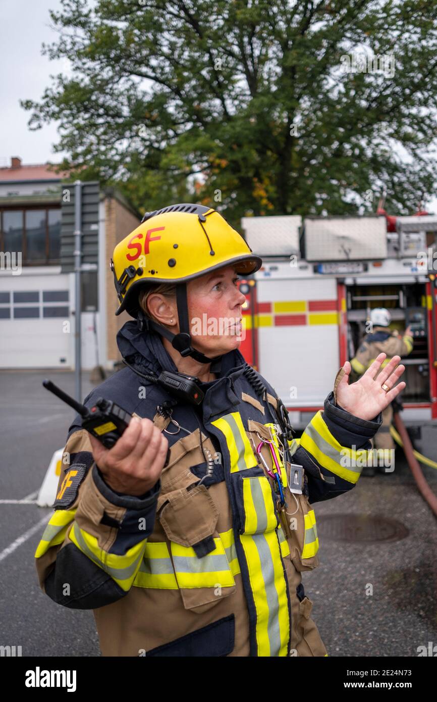 Firefighter talking via walkie talkie Stock Photo - Alamy
