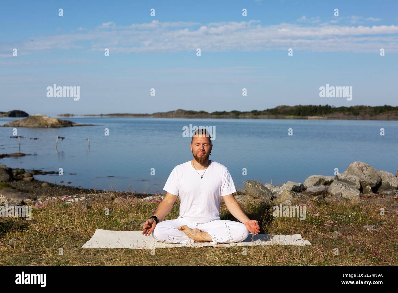 Man meditating at sea Stock Photo - Alamy