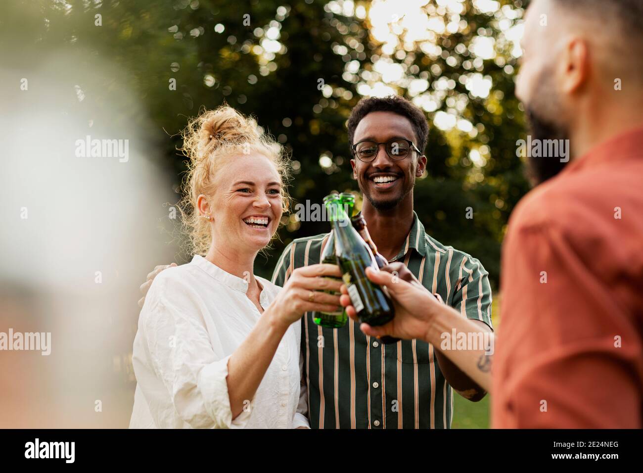 Happy friends having beer in garden Stock Photo - Alamy