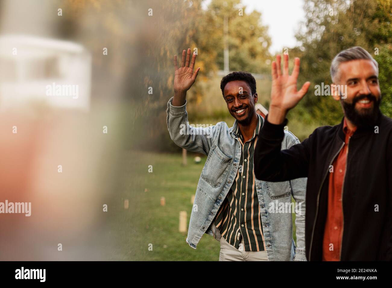 Two men waving hi-res stock photography and images - Alamy