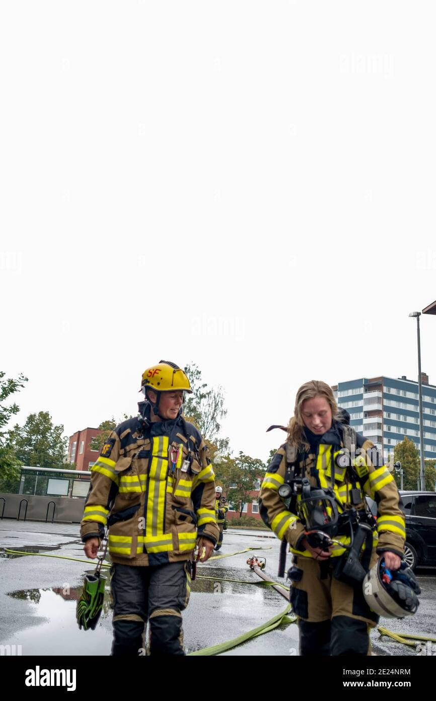 Female firefighters talking together Stock Photo - Alamy
