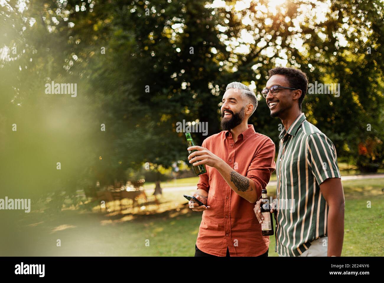 Happy friends having beer in garden Stock Photo - Alamy