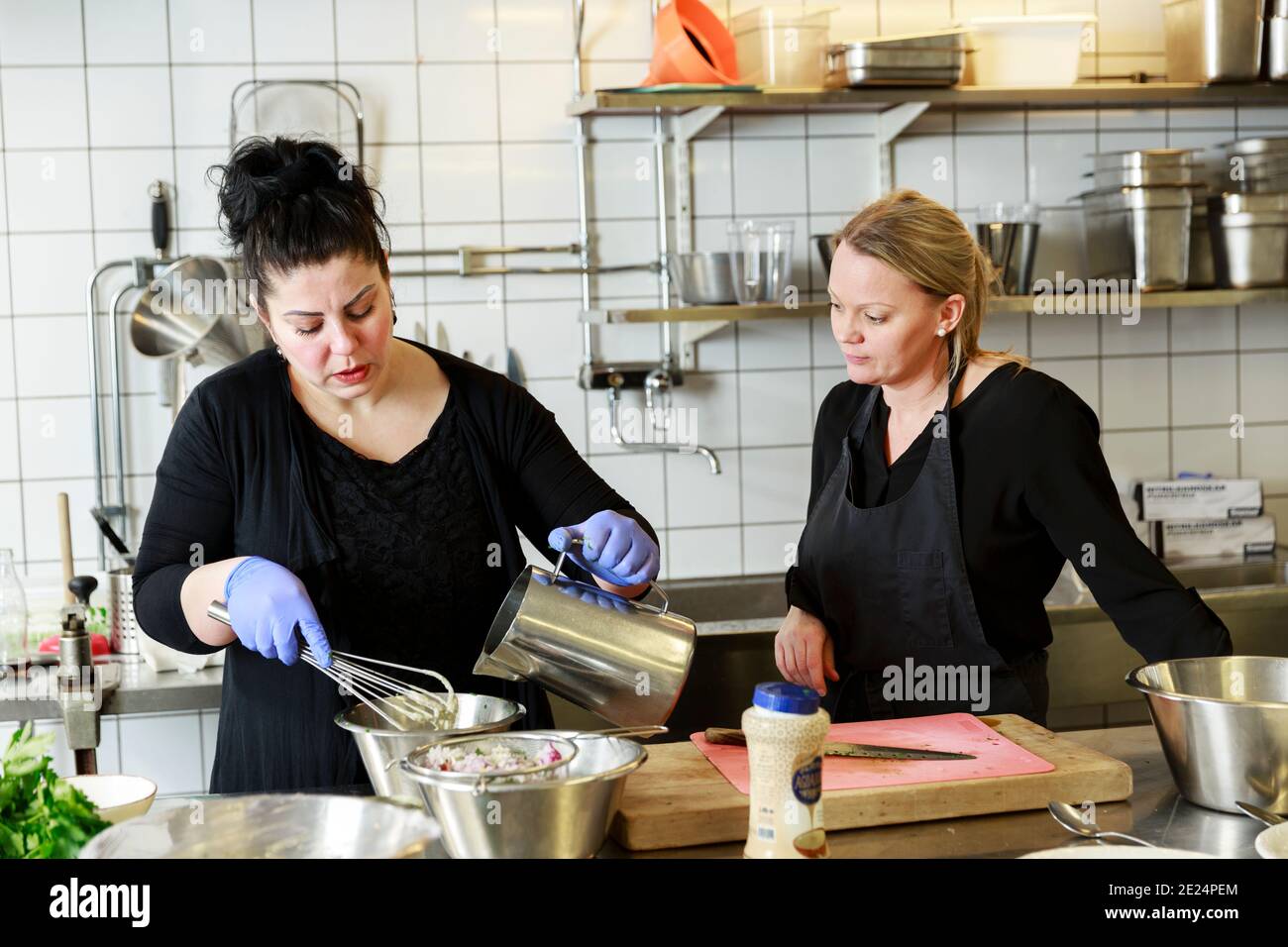 Women preparing food in restaurant kitchen Stock Photo - Alamy