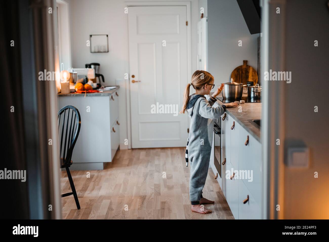 Smiling girl cooking in kitchen Stock Photo - Alamy
