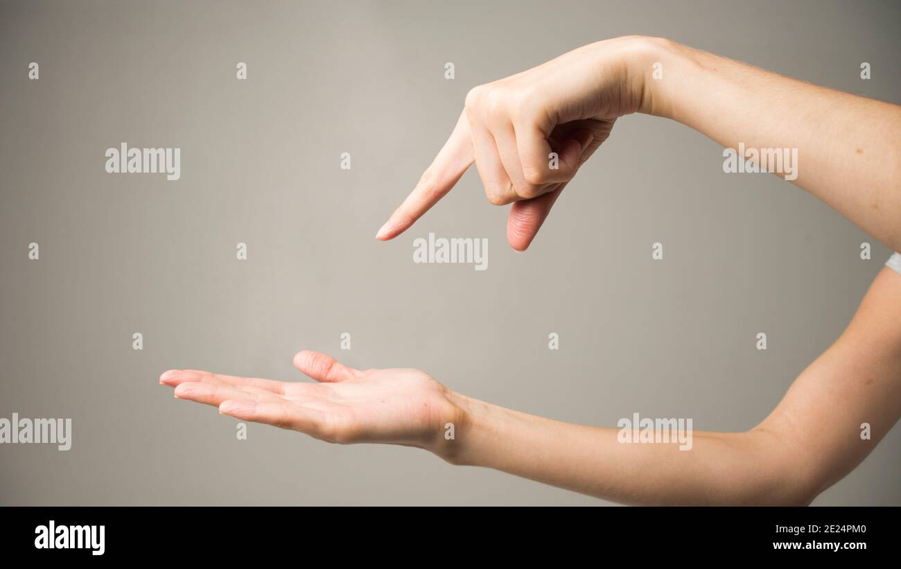 young woman shows something Stock Photo - Alamy