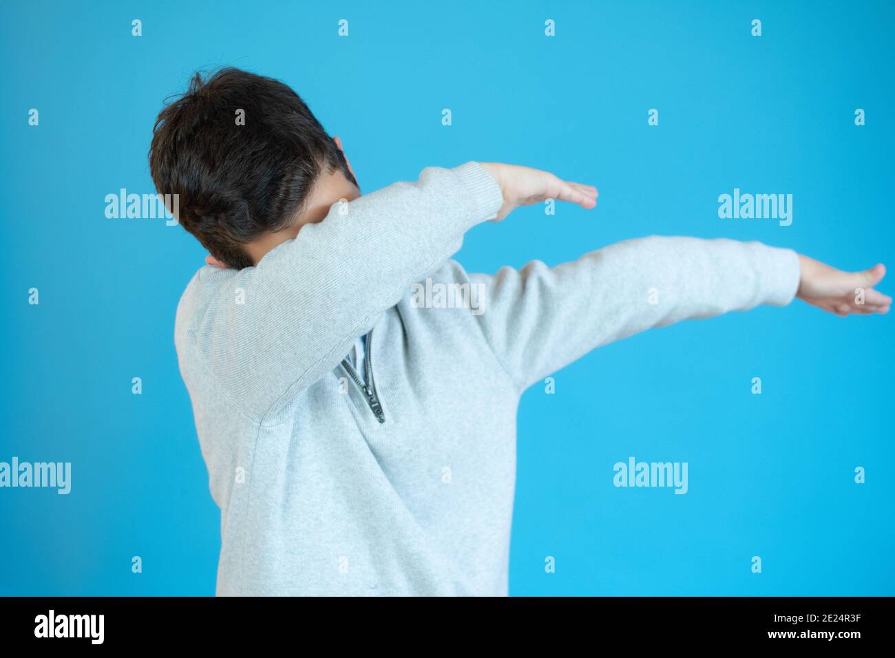 Cheerful little sportive boy child doing dab dance move, gesture while ...