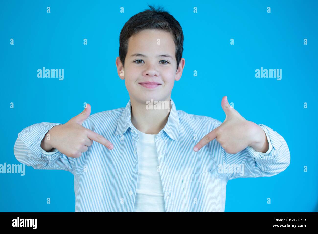 A boy is pointing at himself isolated on the blue background Stock ...