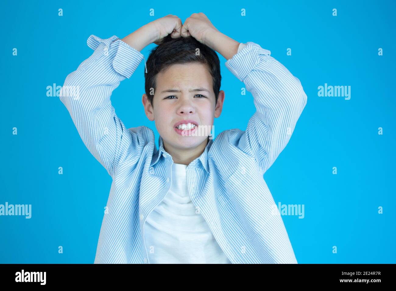 Young boy scratching his head isolated over blue background Stock Photo ...