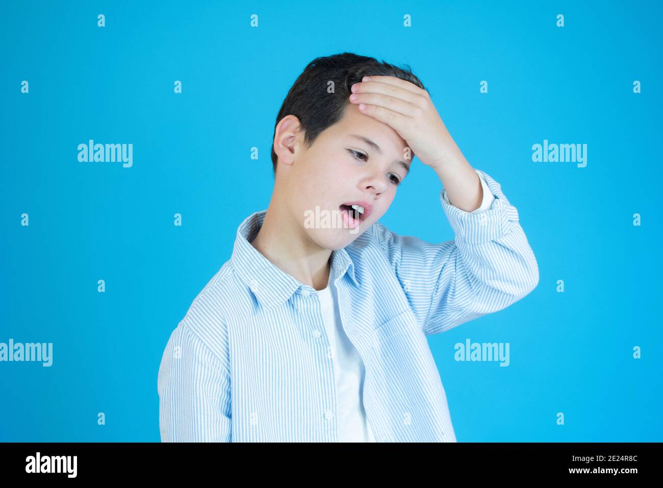 Young boy scratching his head isolated over blue background Stock Photo ...