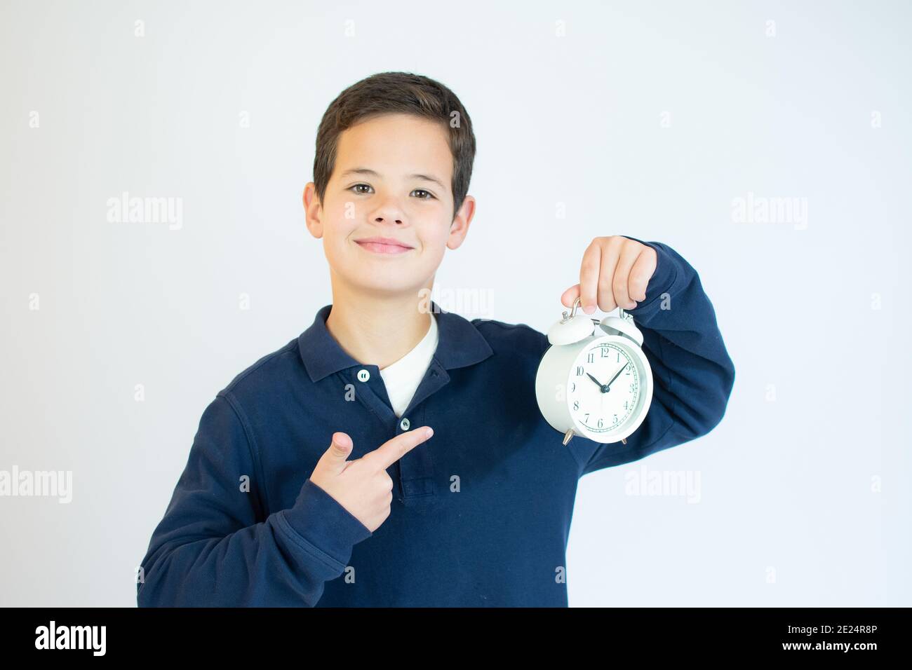 School boy showing alarm clock. Isolated on white background Stock ...