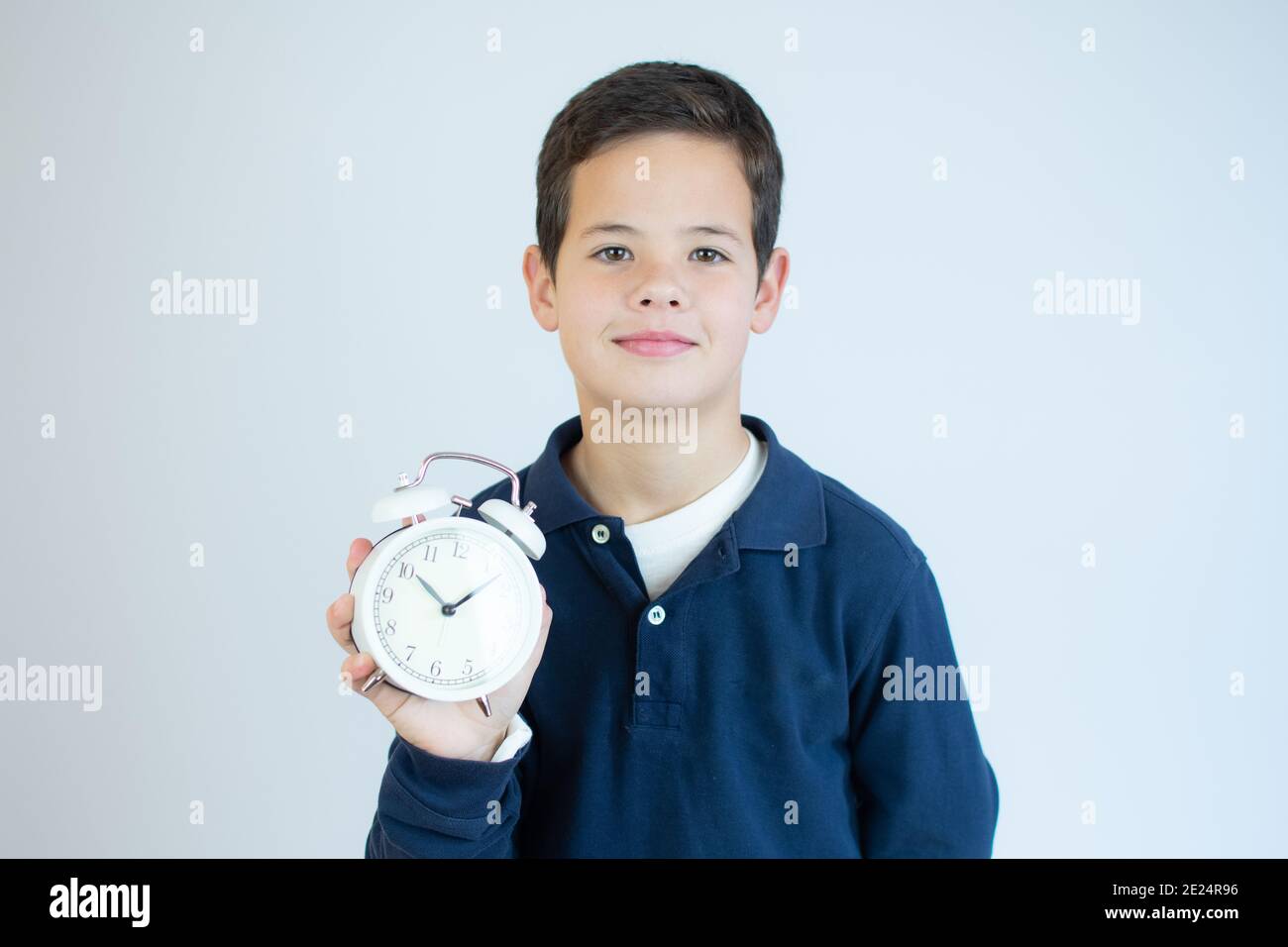 School boy showing alarm clock. Isolated on white background Stock ...