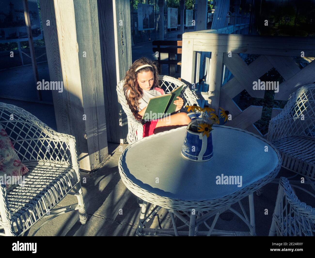 Girl sitting on terrace hi-res stock photography and images - Alamy