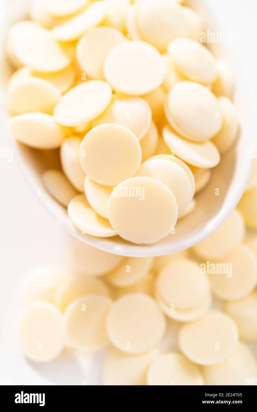White round chocolate chips for melting chocolate shapes on a white ...
