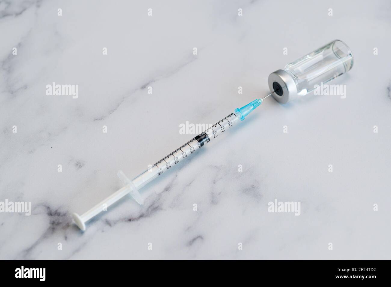 Medical syringe and needle for hypodermic injection on a marble counter ...