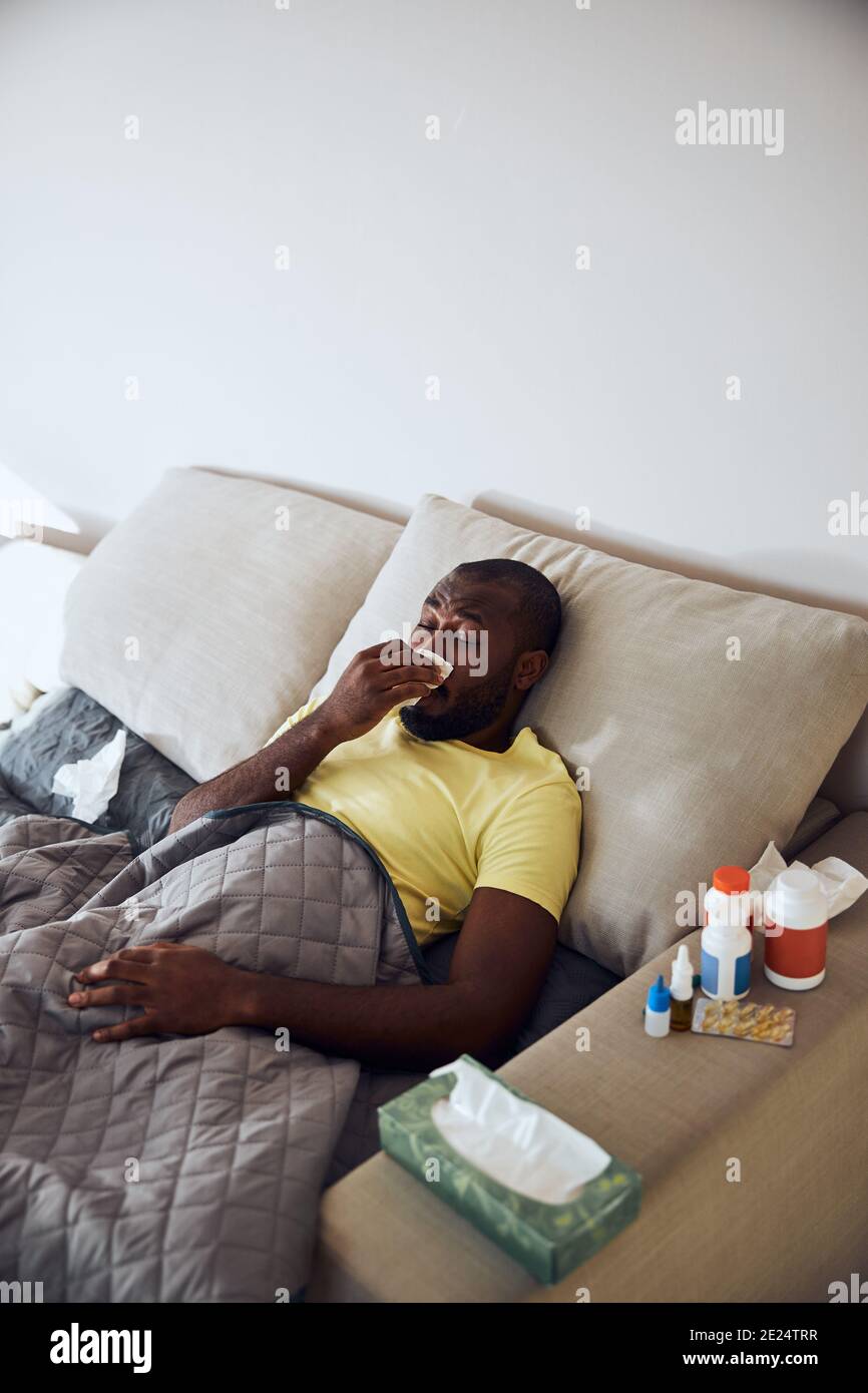 Multiethnic man feeling unwell because of sickness Stock Photo - Alamy