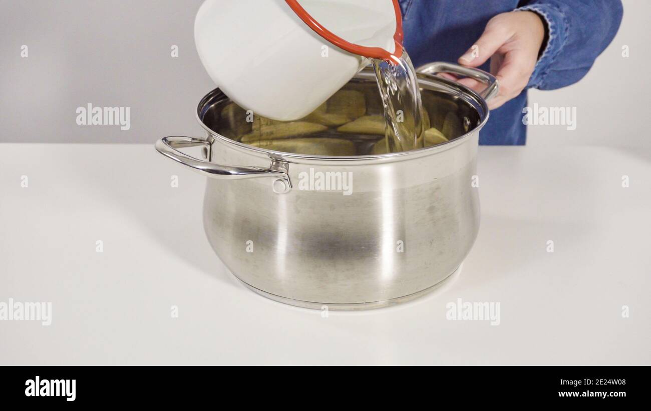 Step by step. Boiling peeled large potatoes in a cooking pot Stock ...