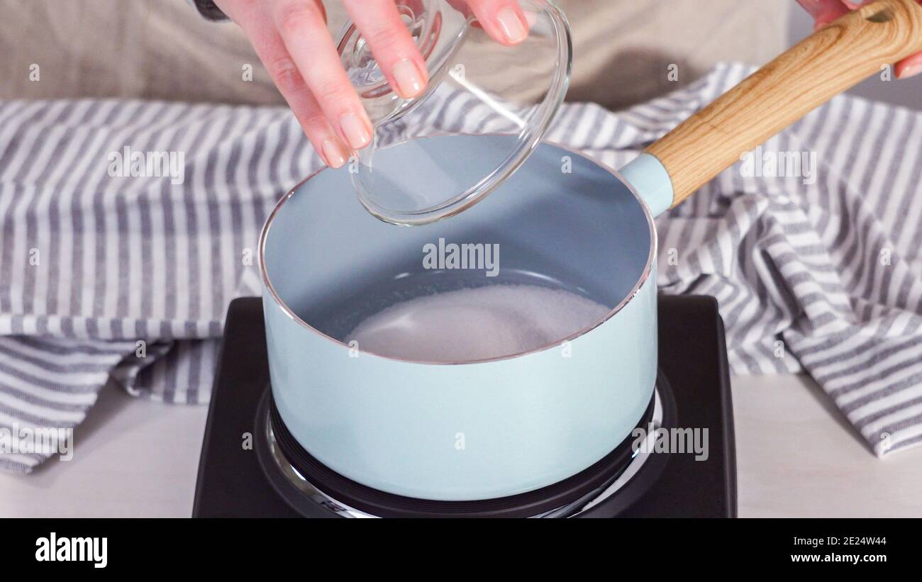 Step by step. Preparing sugar syrup in a small saucepan over an ...