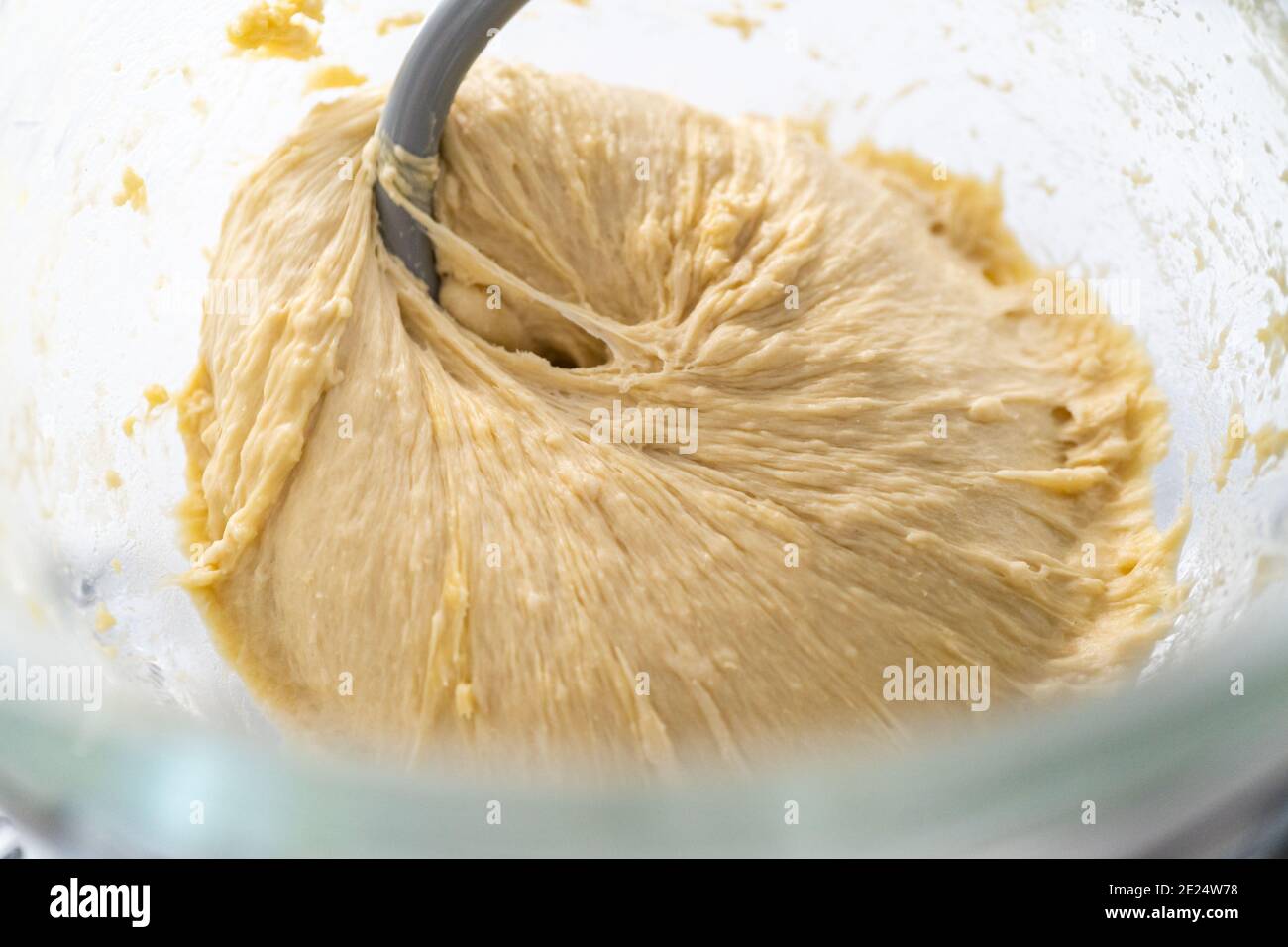 Mixing ingredients in kitchen mixer to bake homemade brioche buns Stock ...