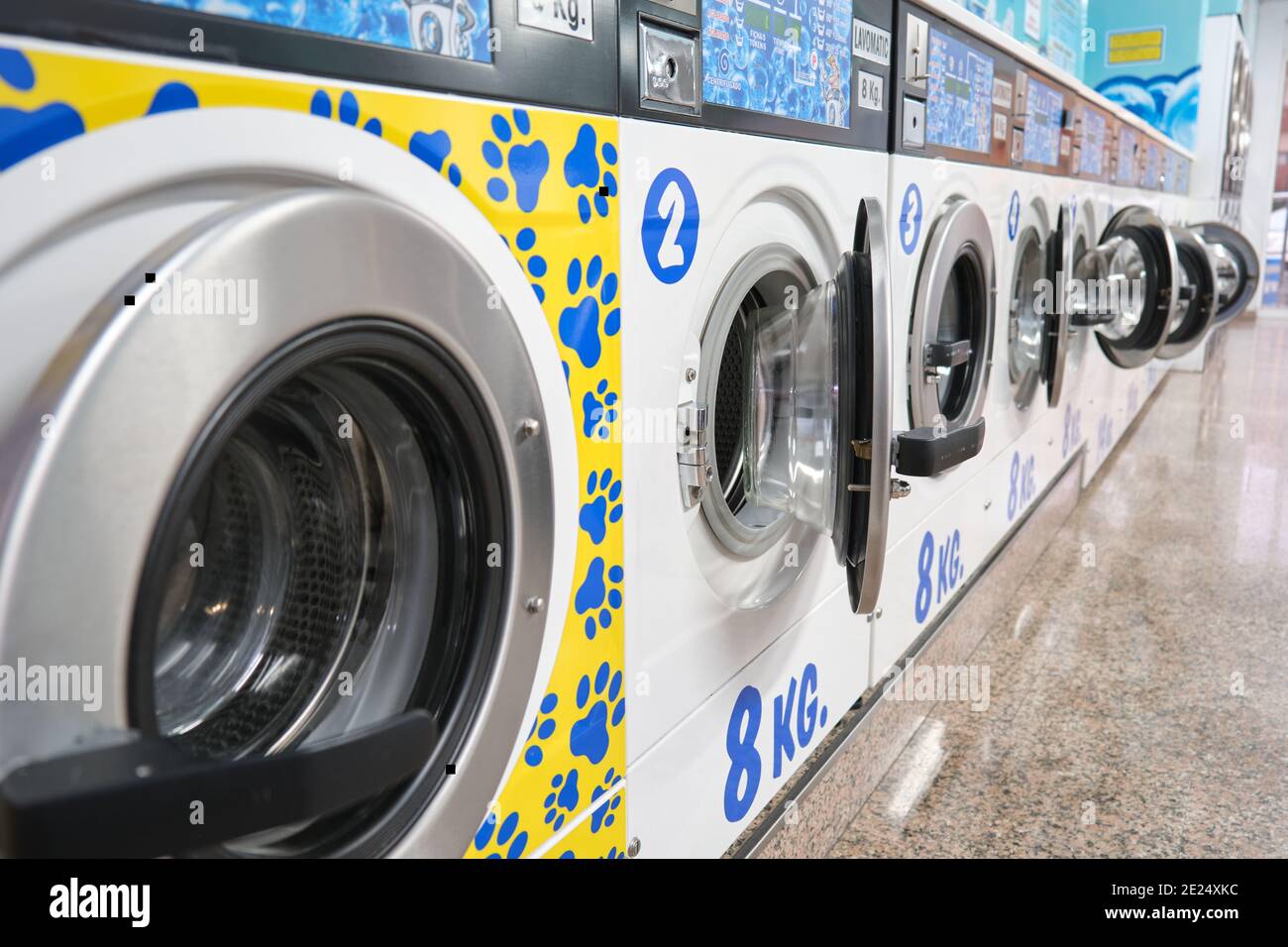 White Washing Machines At laundry service side view Stock Photo - Alamy