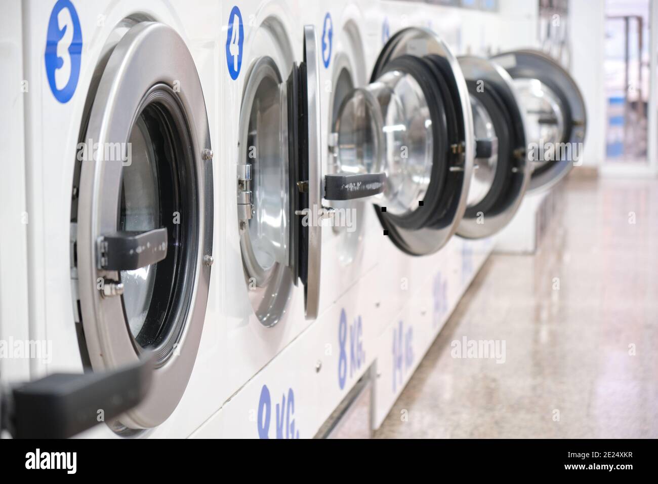 White Washing Machines At laundry service side view Stock Photo - Alamy
