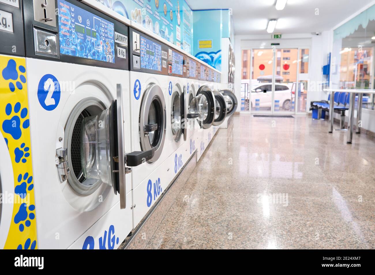 White Washing Machines At laundry service side view Stock Photo - Alamy