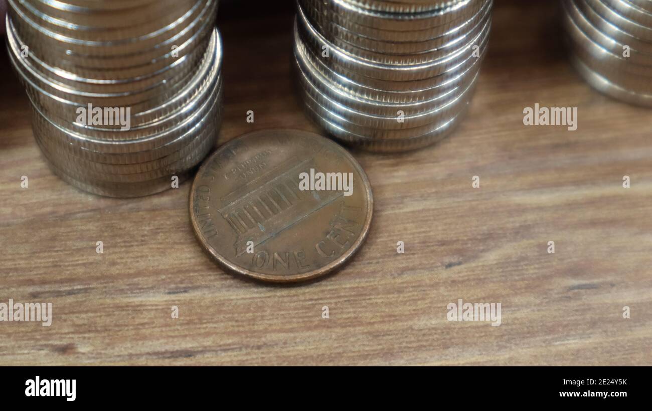 Coins are stacked on a wooden work table. Stock photo of many cents ...