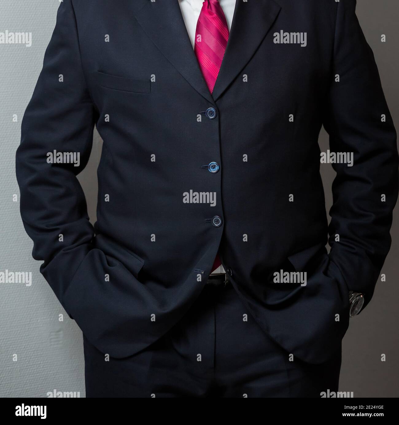 Good-looking unrecognizable man wearing a black suit and a tie, and ...