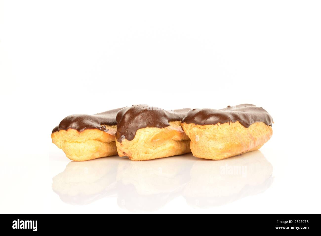 Three chocolate eclairs, close-up, isolated on white Stock Photo - Alamy