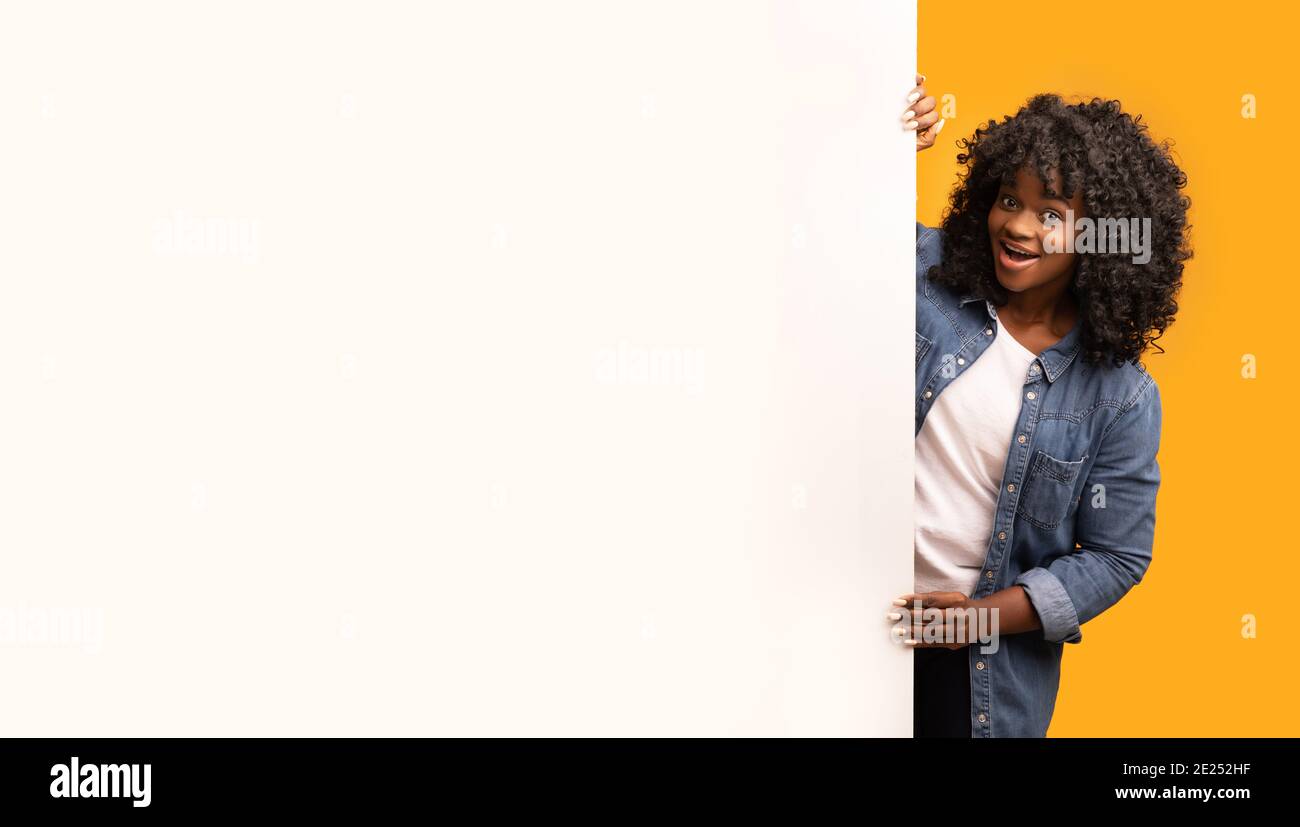 Amazed stylish african lady looking at blank advertisement board Stock ...