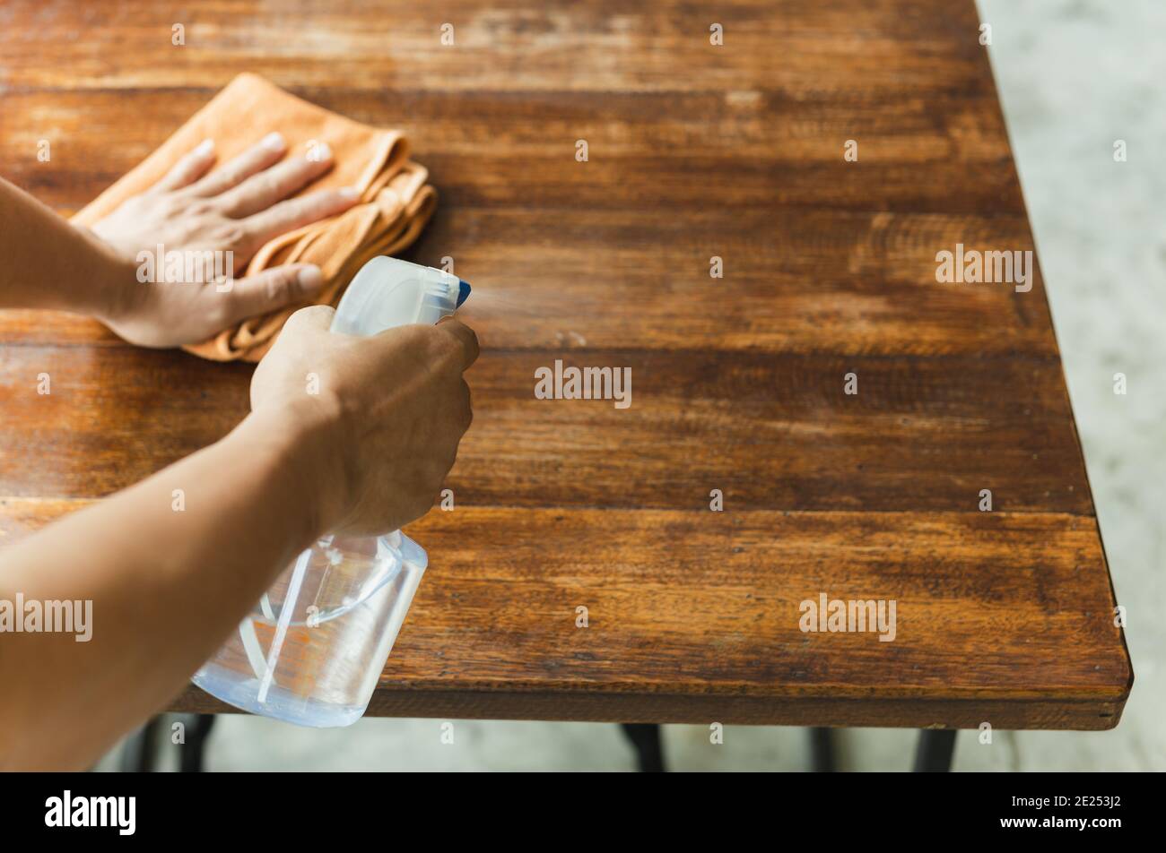Waiter cleaning table with disinfectant spray for protect infection ...