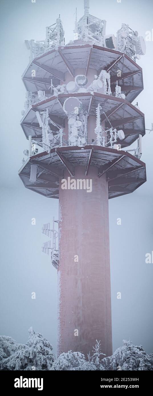 A frozen disused radio tower covered in fresh snow. The frozen antenna ...