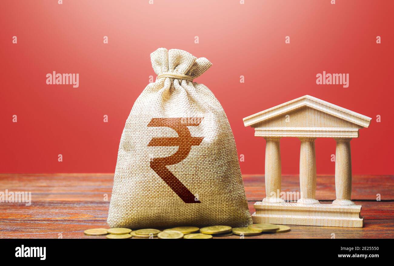 Indian rupee money bag and bank / government building. Tax collection ...