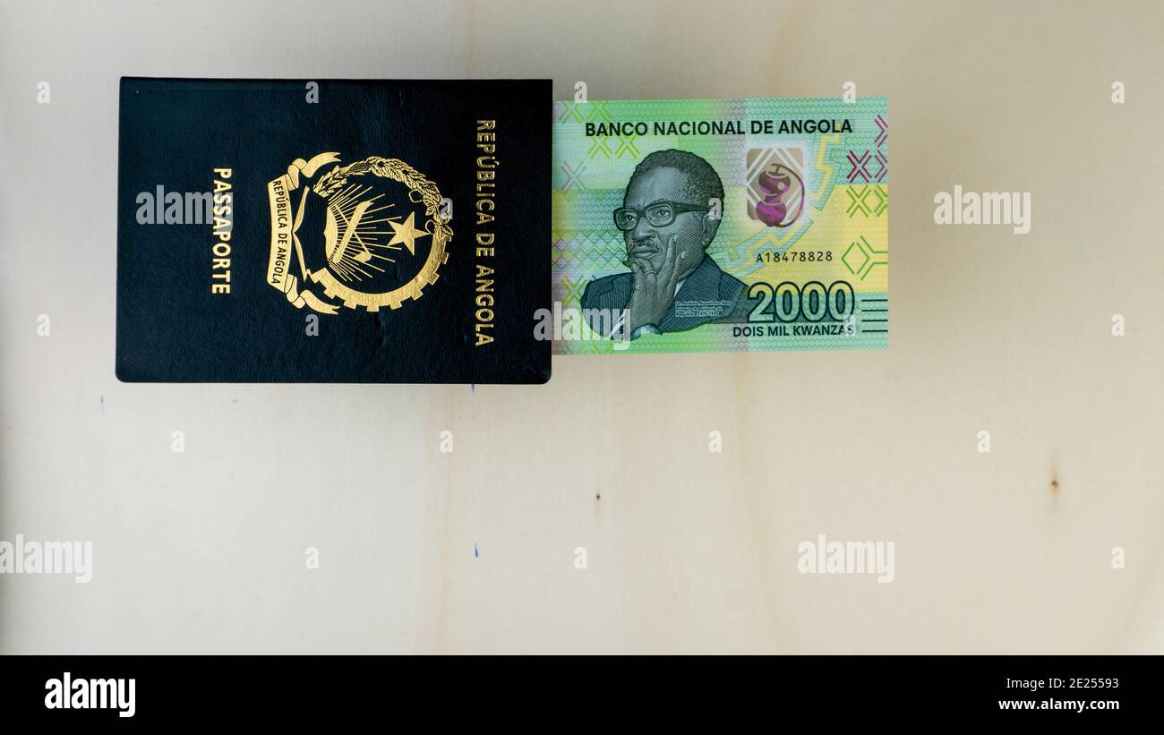 Overhead shot of an Angolan passport and new series of Kwanza banknotes ...
