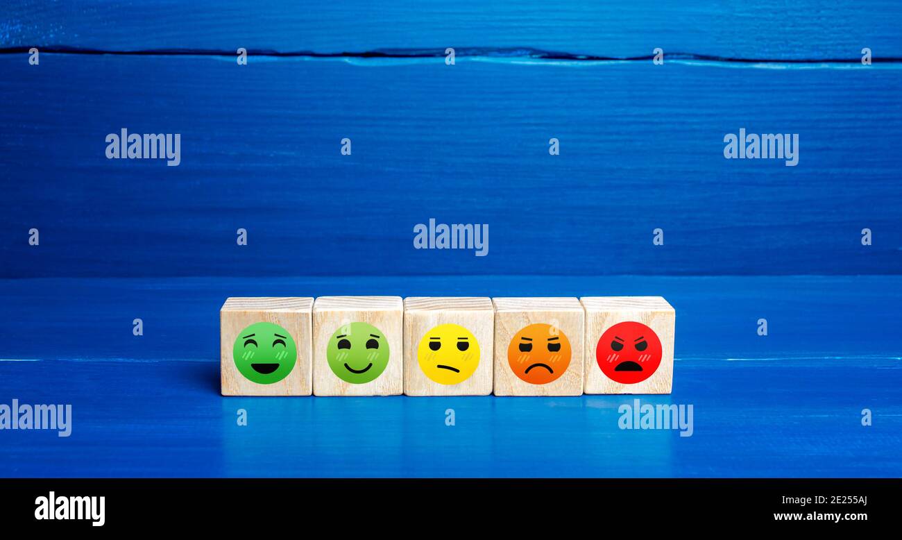 Mood faces from happy to angry on wooden blocks. Concept of rating ...