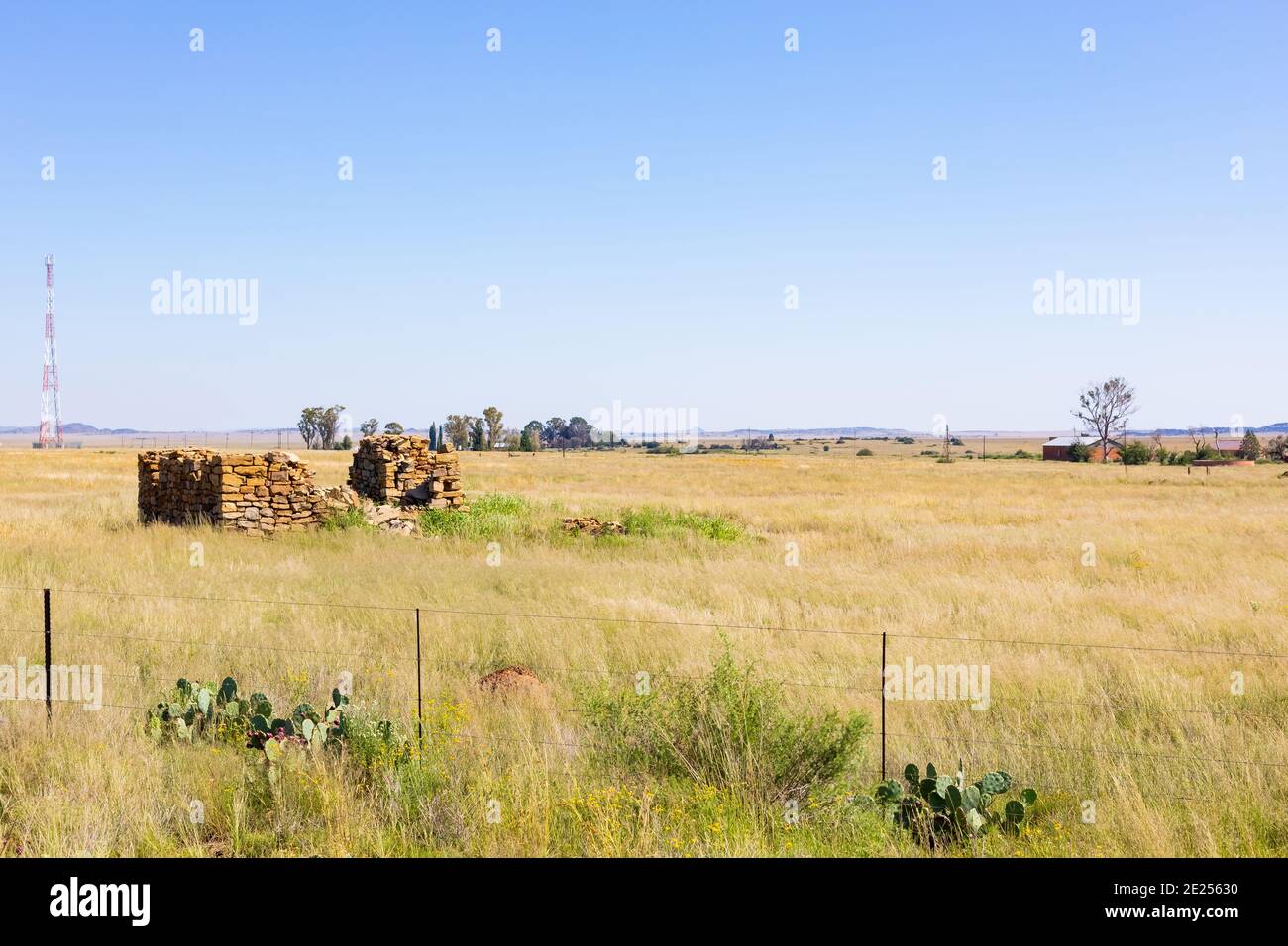 Dry grassland with old ancient building ruins in South Africa under a ...