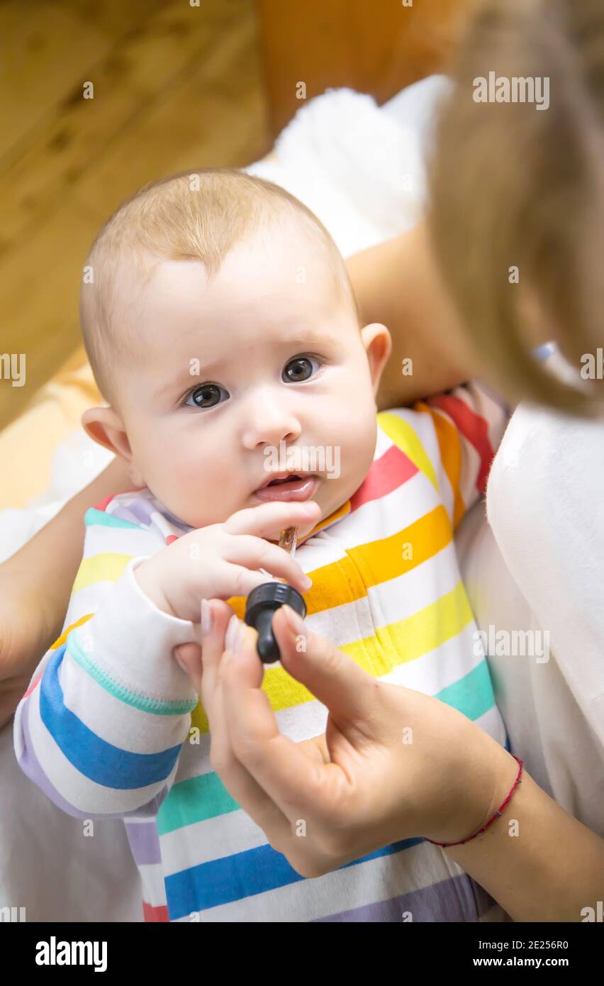 mother gives colic medicine to little baby. Selective focus. child ...