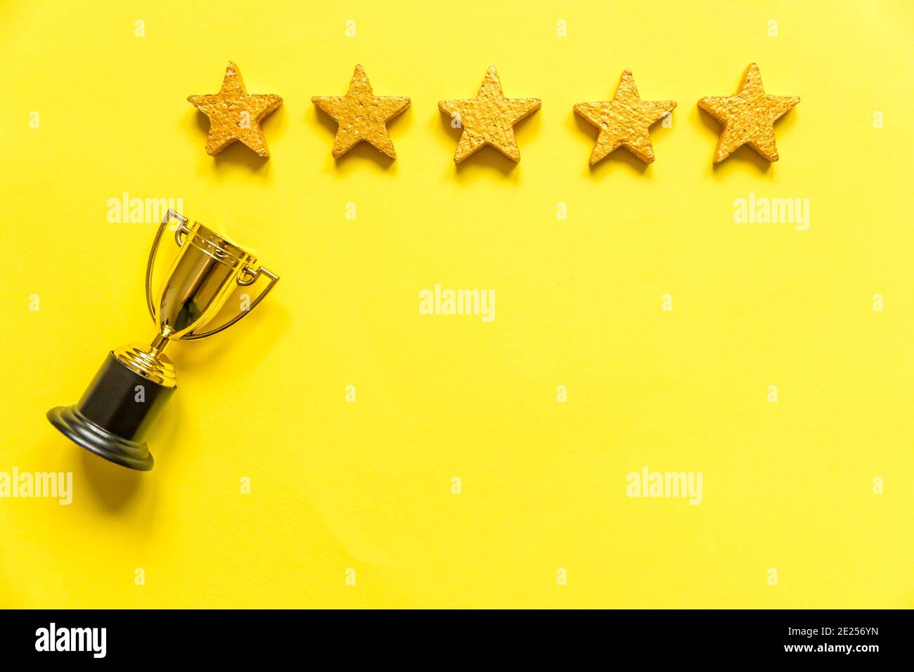 Simply flat lay design winner or champion gold trophy cup and 5 stars ...