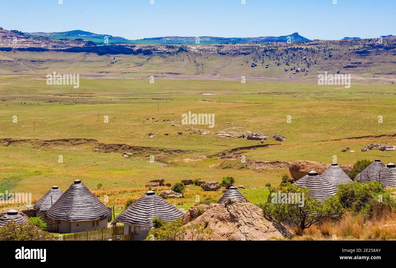 Grassy landscape with rural traditional buildings in South Africa Stock ...