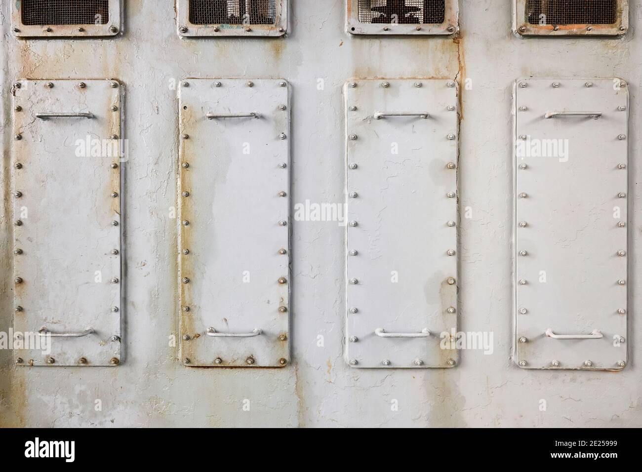 Four metal hatches plate on compressor for revision close-up with oiler ...