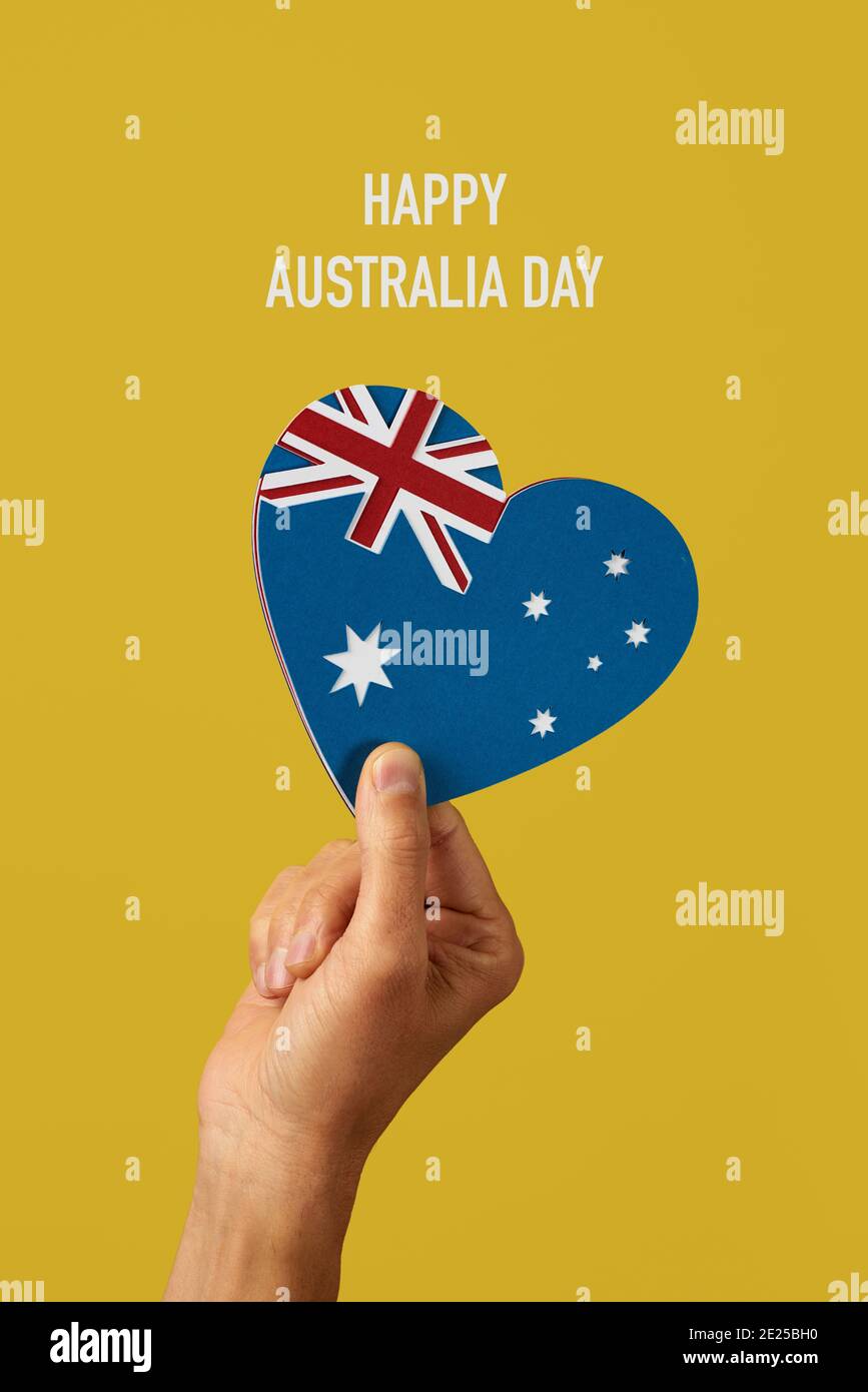 closeup of the hand of a man holding an australian flag in the shape of ...