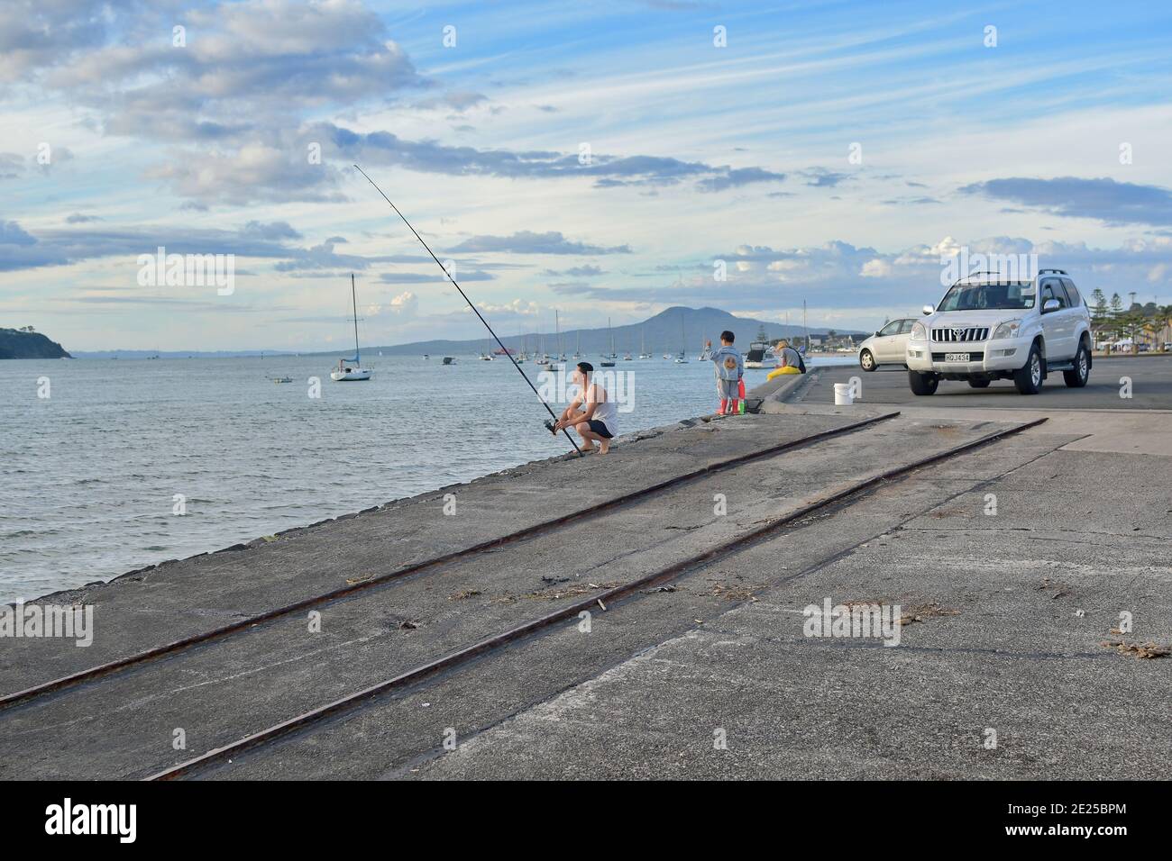 AUCKLAND, NEW ZEALAND - Jan 01, 2021: View of people fishing from ...