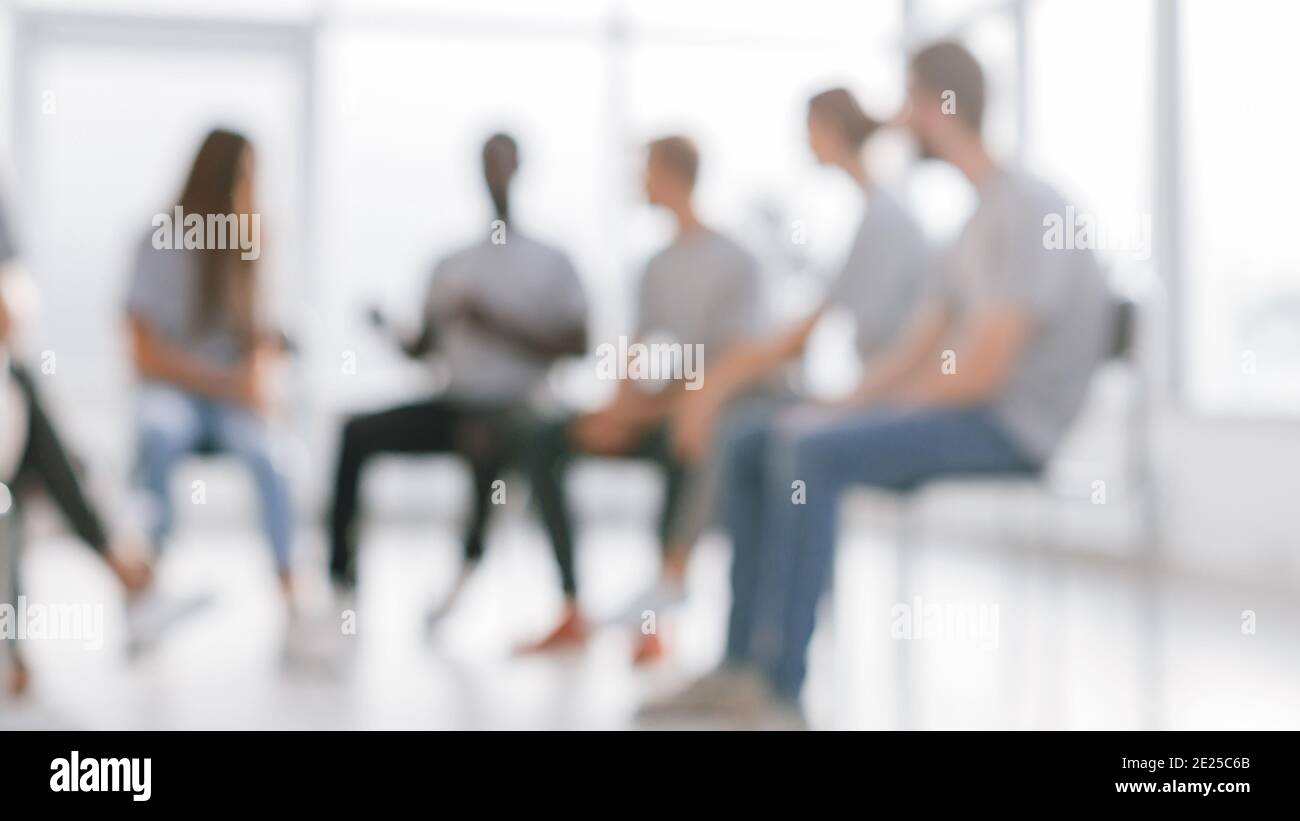 background image of a group of young people at a meeting in a ...