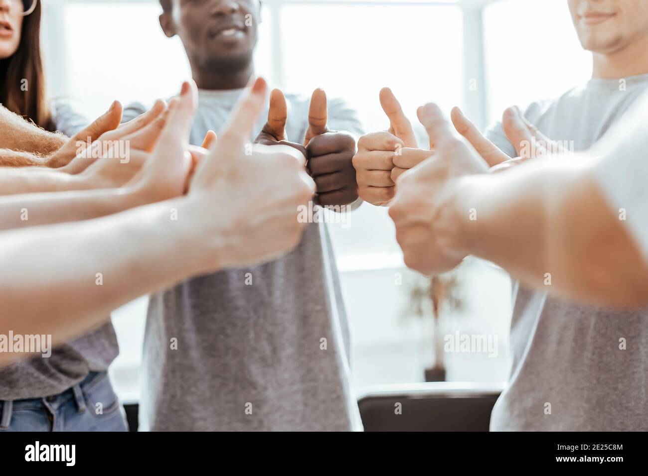 close up. group of young people showing thumbs up Stock Photo - Alamy