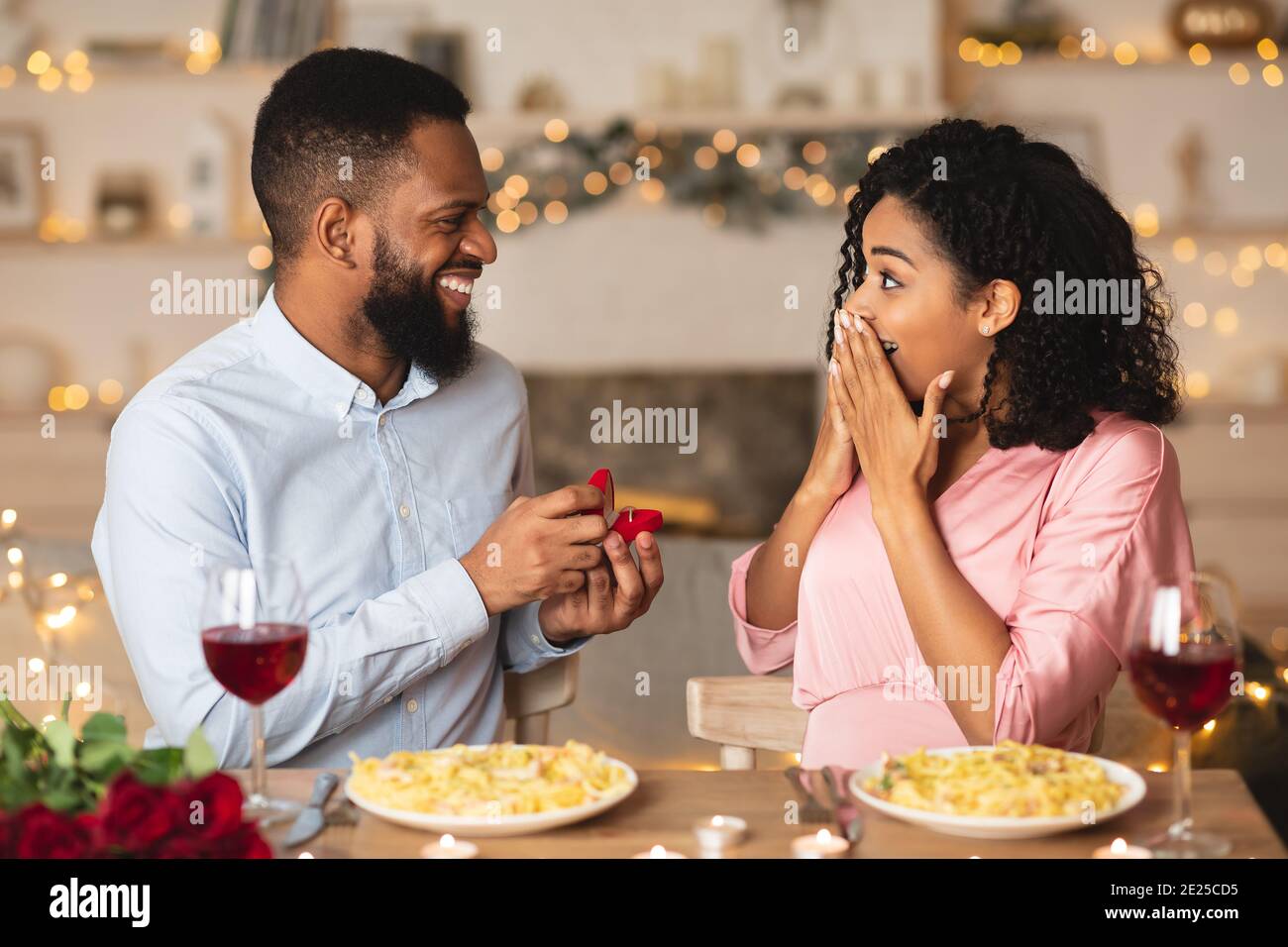 Young black man making proposal with ring to his woman Stock Photo - Alamy